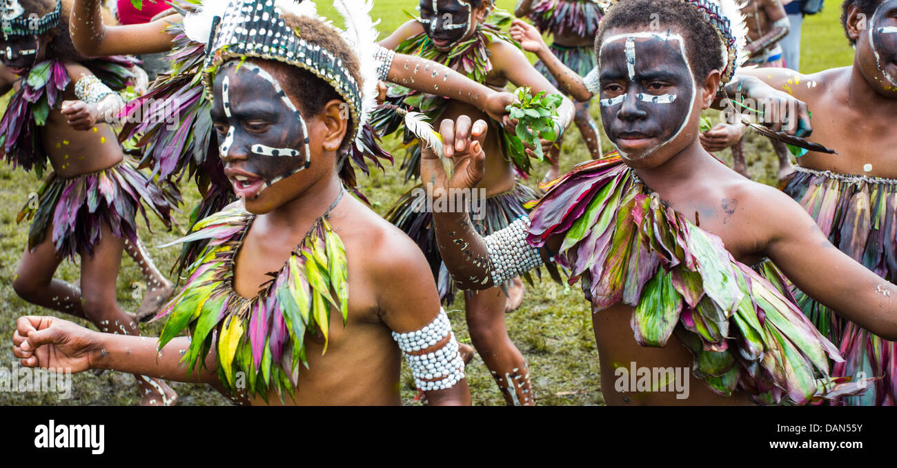Children wearing traditional leaf costumes and dancing at the Goroka ...