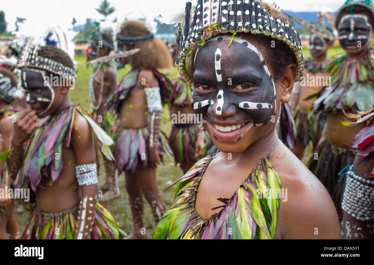 Children wearing traditional leaf costumes and dancing at the Goroka ...