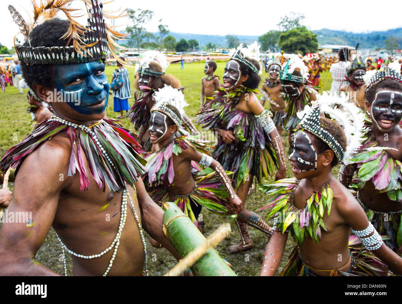 Children wearing traditional leaf costumes and dancing at the Goroka ...