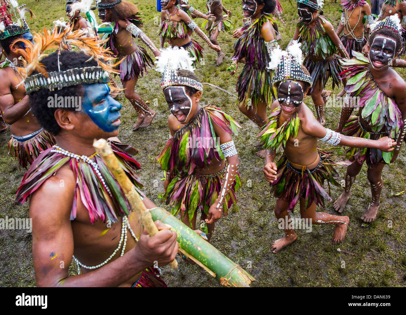 Children wearing traditional leaf costumes and dancing at the Goroka ...