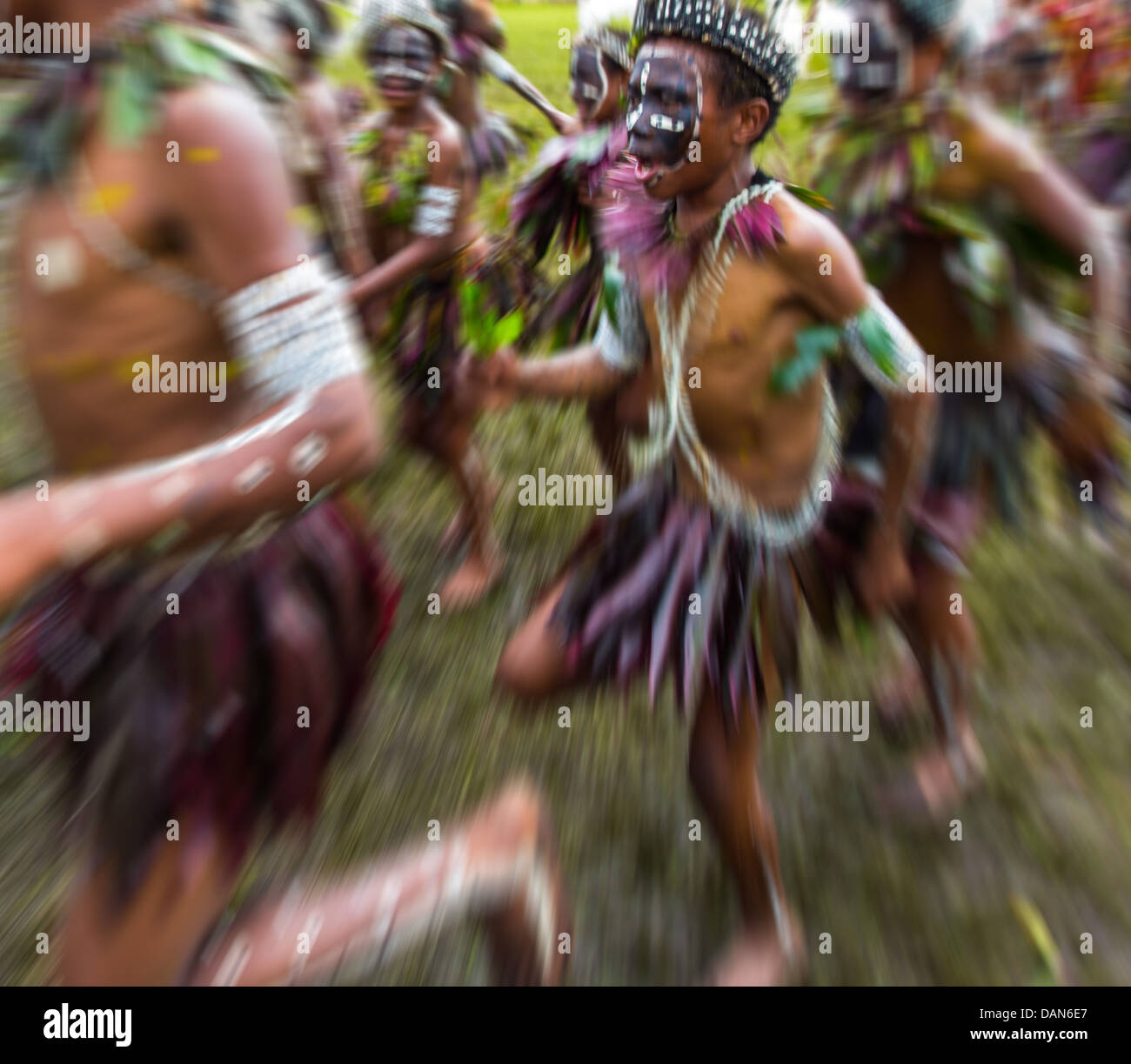 Children wearing traditional leaf costumes and dancing at the Goroka ...