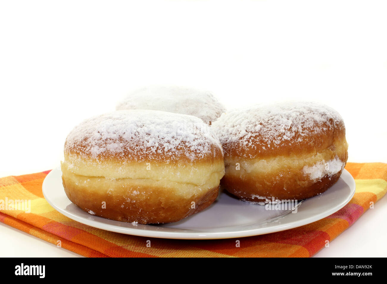 a plate of donuts on a white background Stock Photo - Alamy