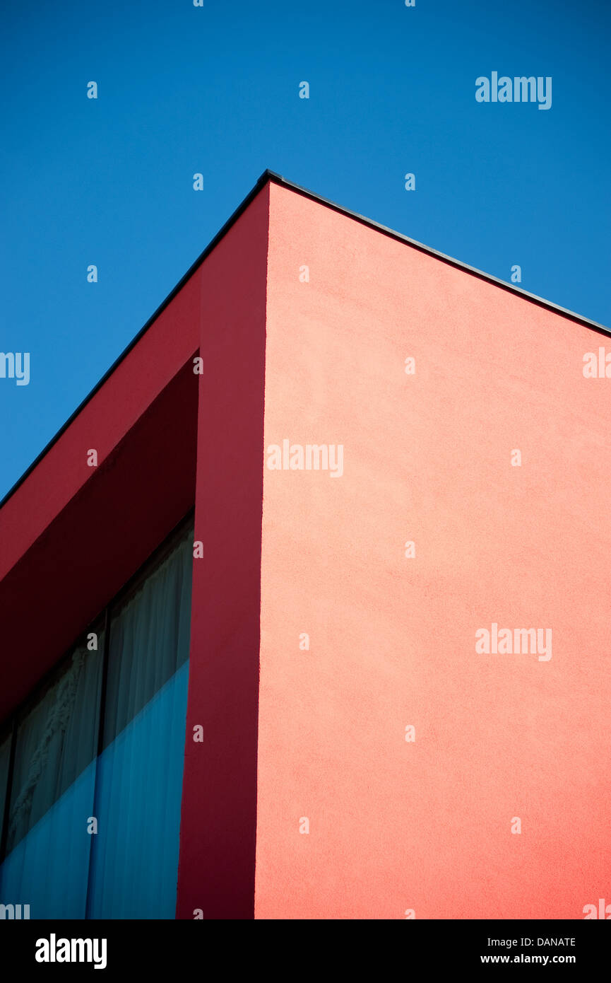 Modern Red Rendered commercial building stark Stock Photo - Alamy