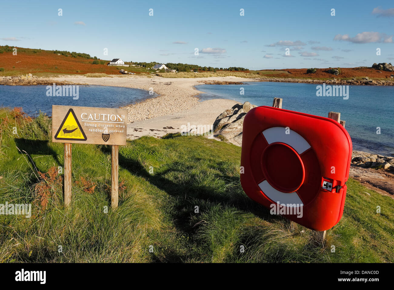 sign warning of strong currents on sandbar together with life buoy on ...