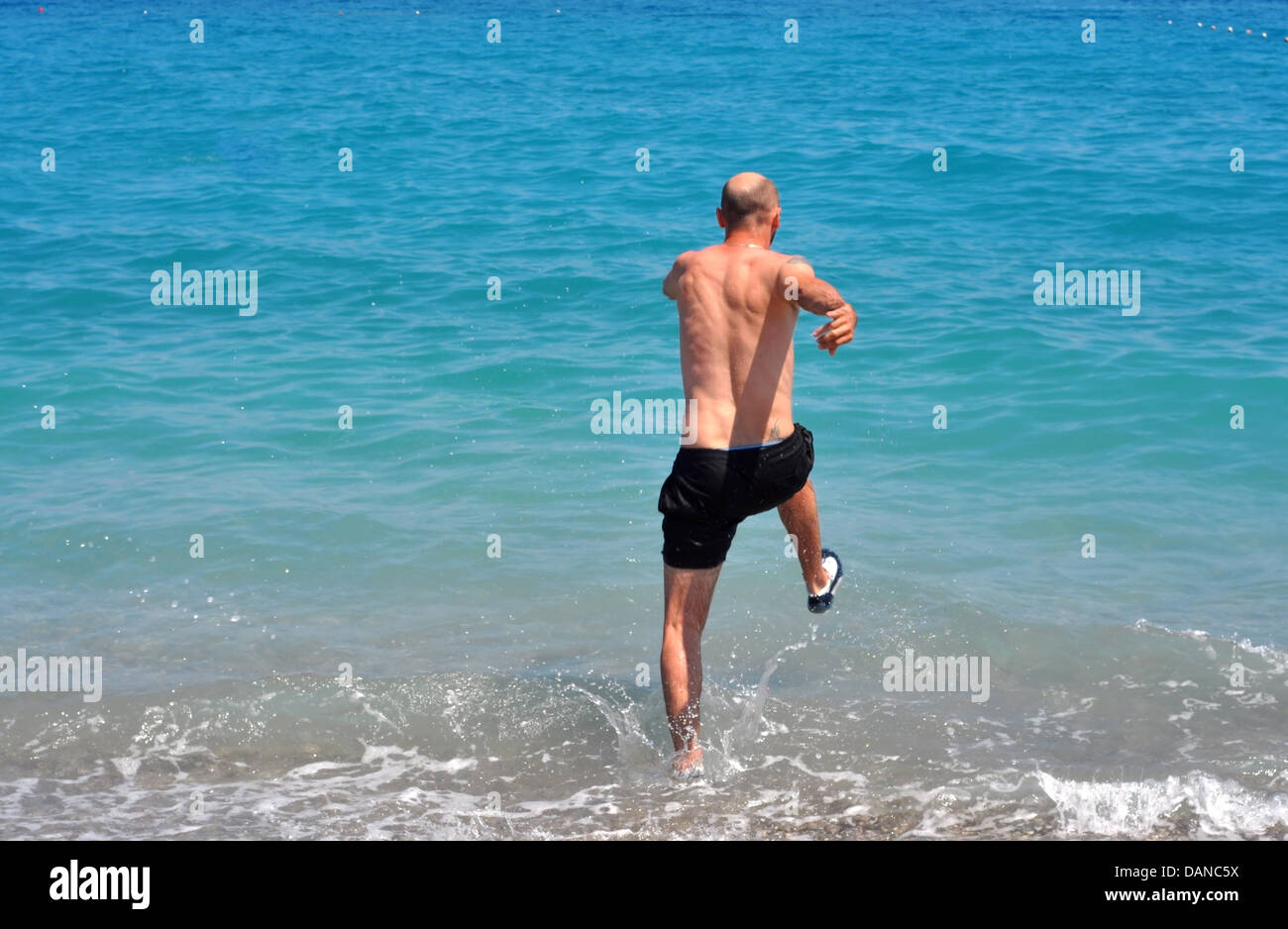 Man running into the sea hi-res stock photography and images - Alamy