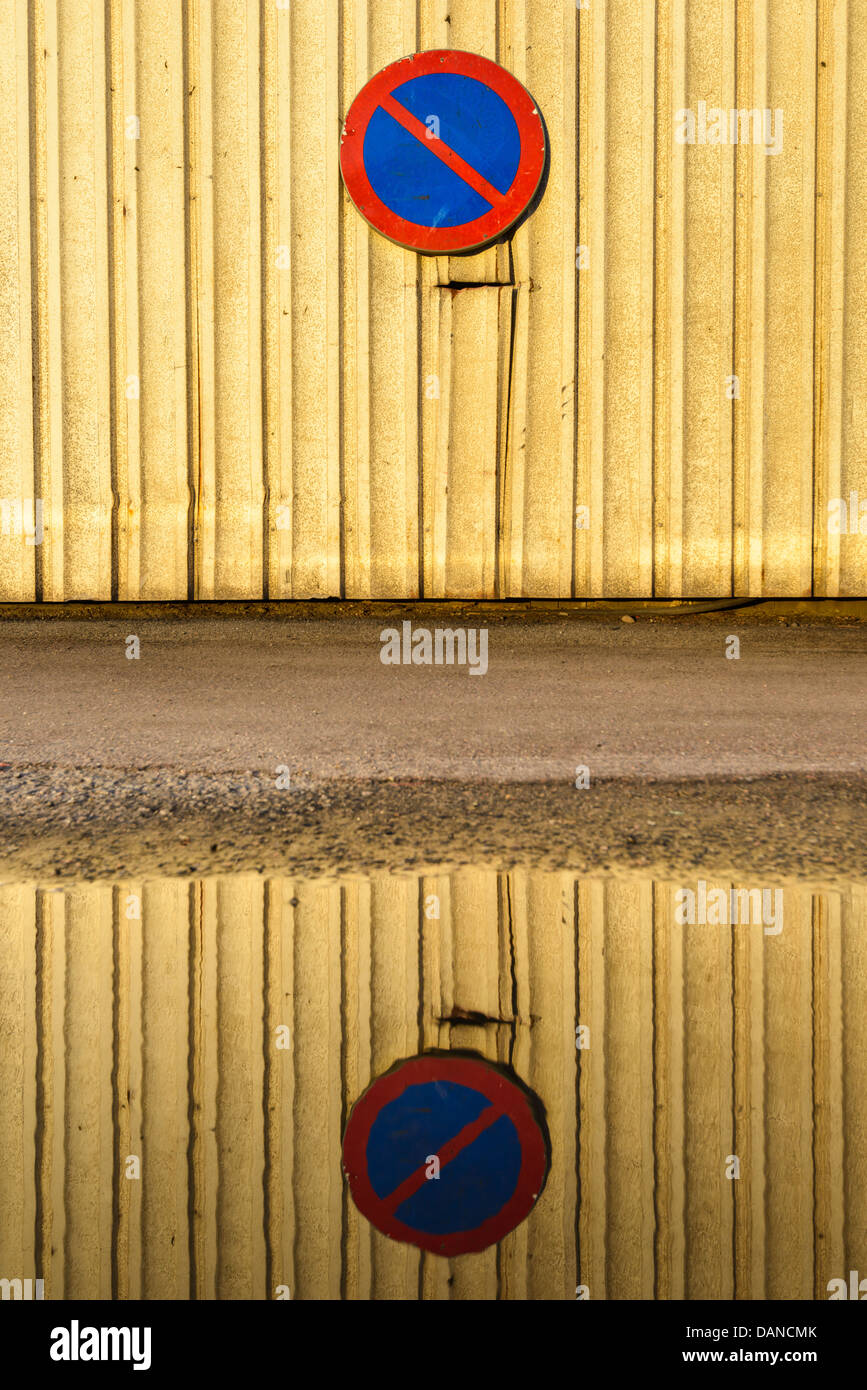 "No Parking Zone" sign reflected in puddle Stock Photo - Alamy
