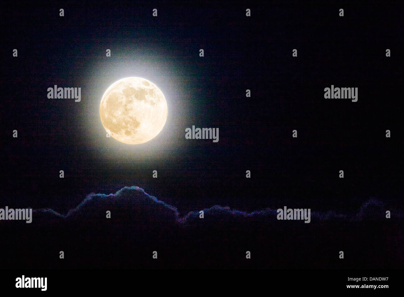 Forest fire smoke colors the full moon rising over Rocky Mountains ...