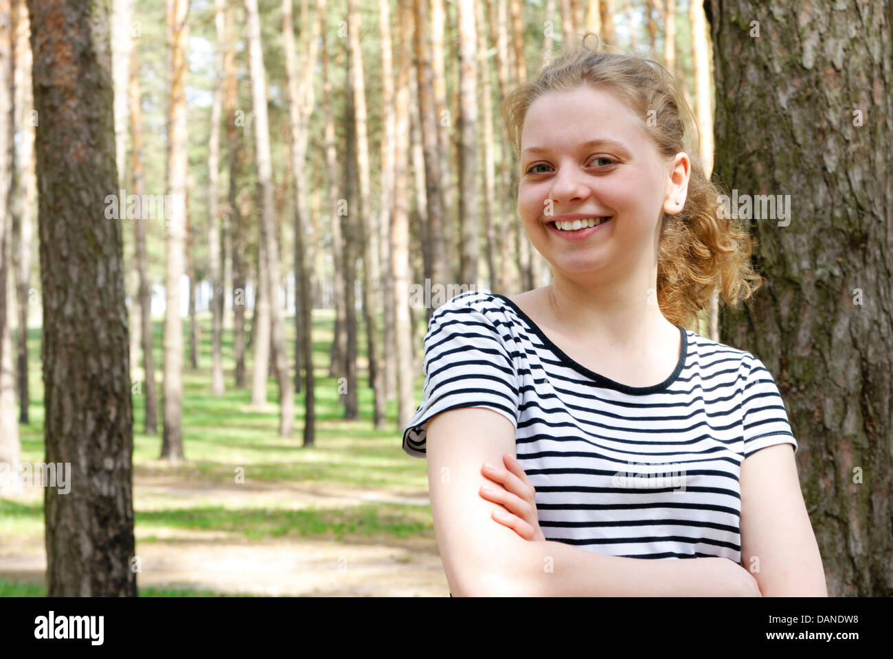 Beautiful girl is smiling in the forest Stock Photo - Alamy