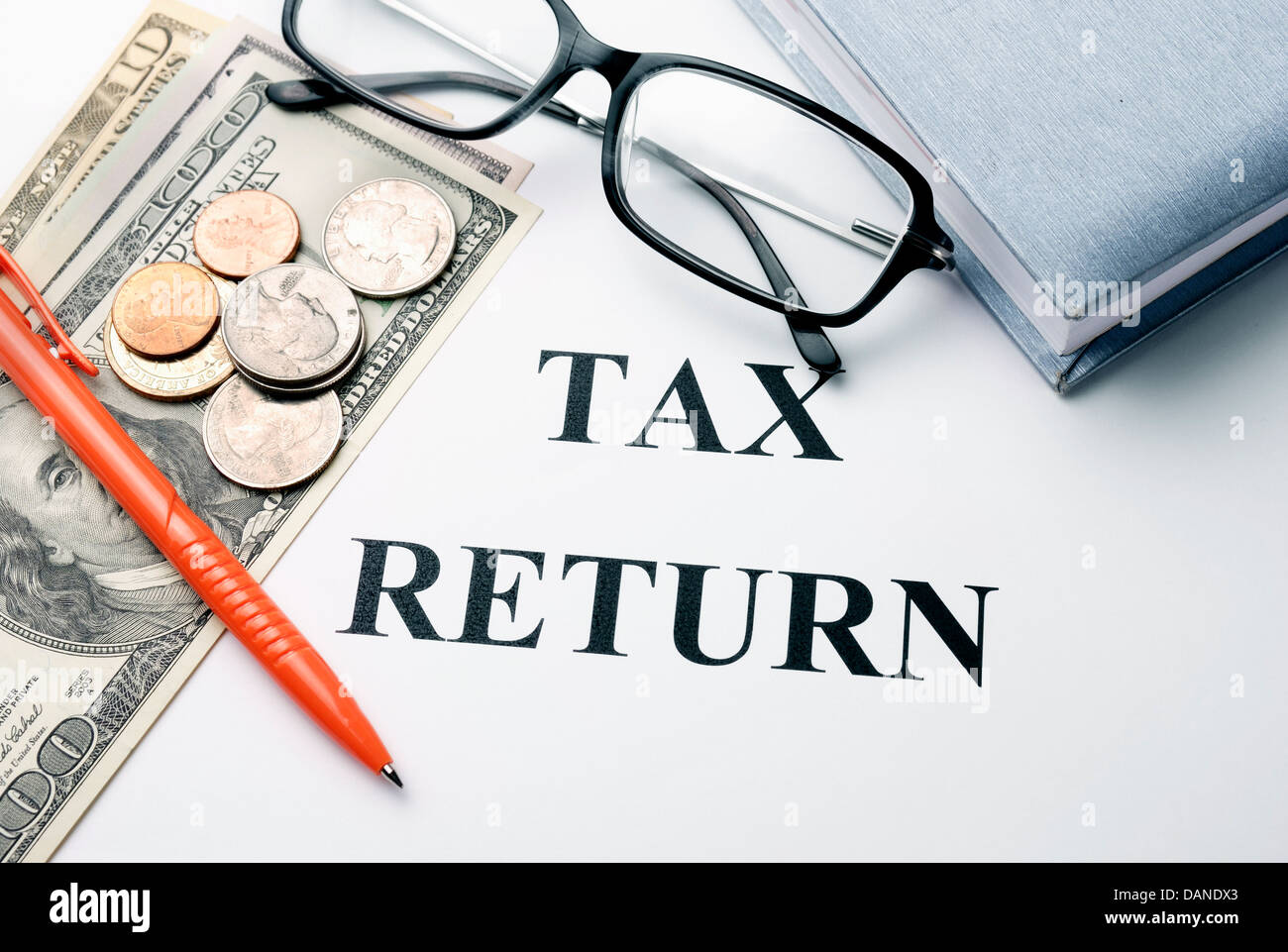 Tax return papers with glasses, pen and money Stock Photo - Alamy
