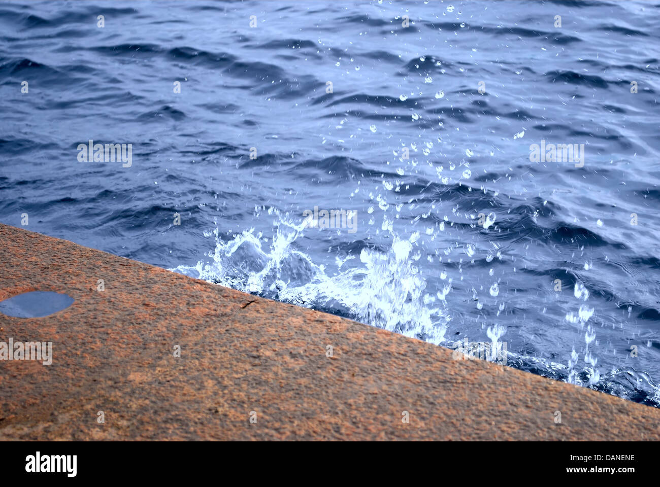 The splashing of water and spray the granite embankment Stock Photo - Alamy