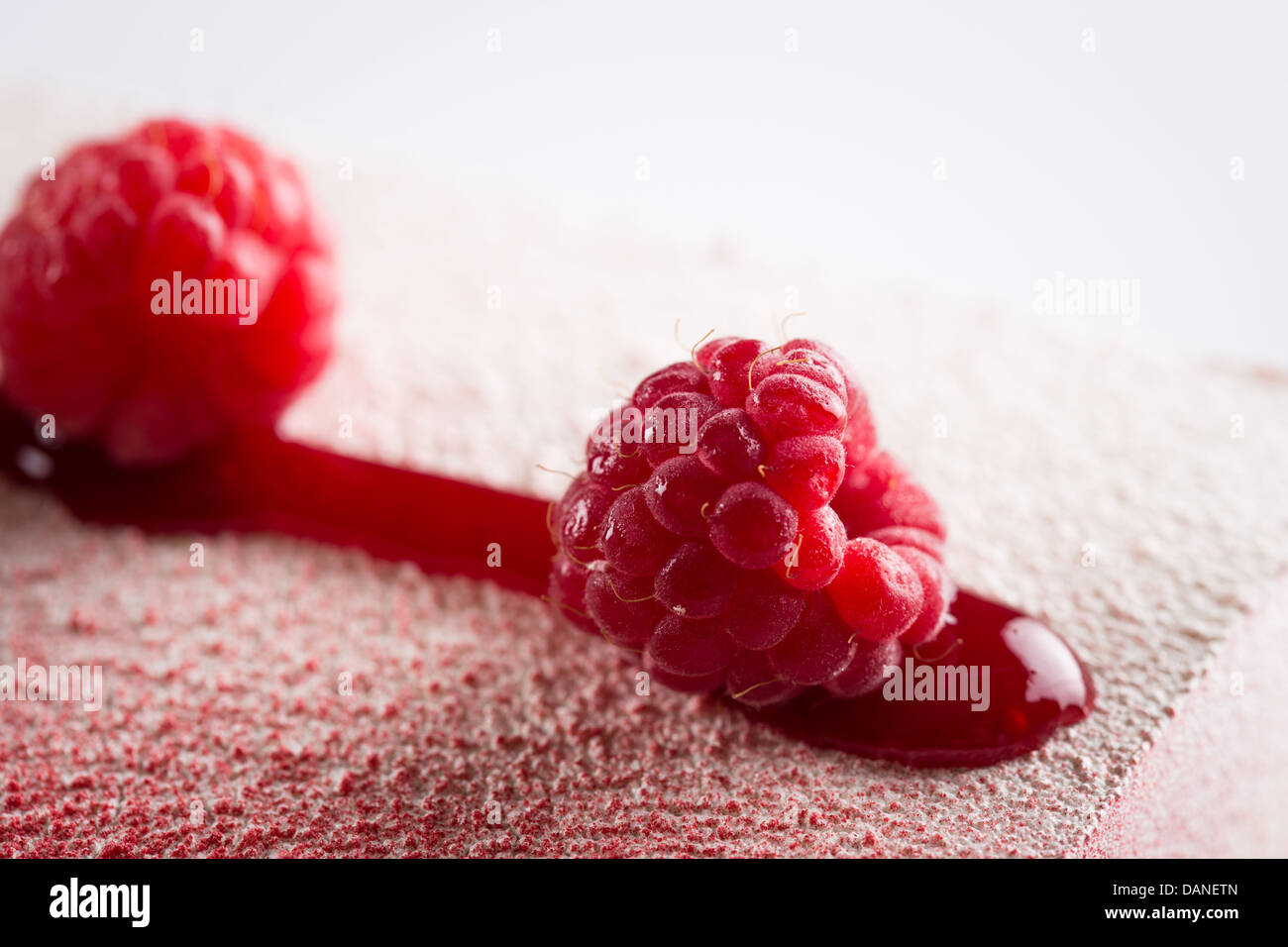 Detail of a raspberry in a red fruits mousse close-up Stock Photo - Alamy