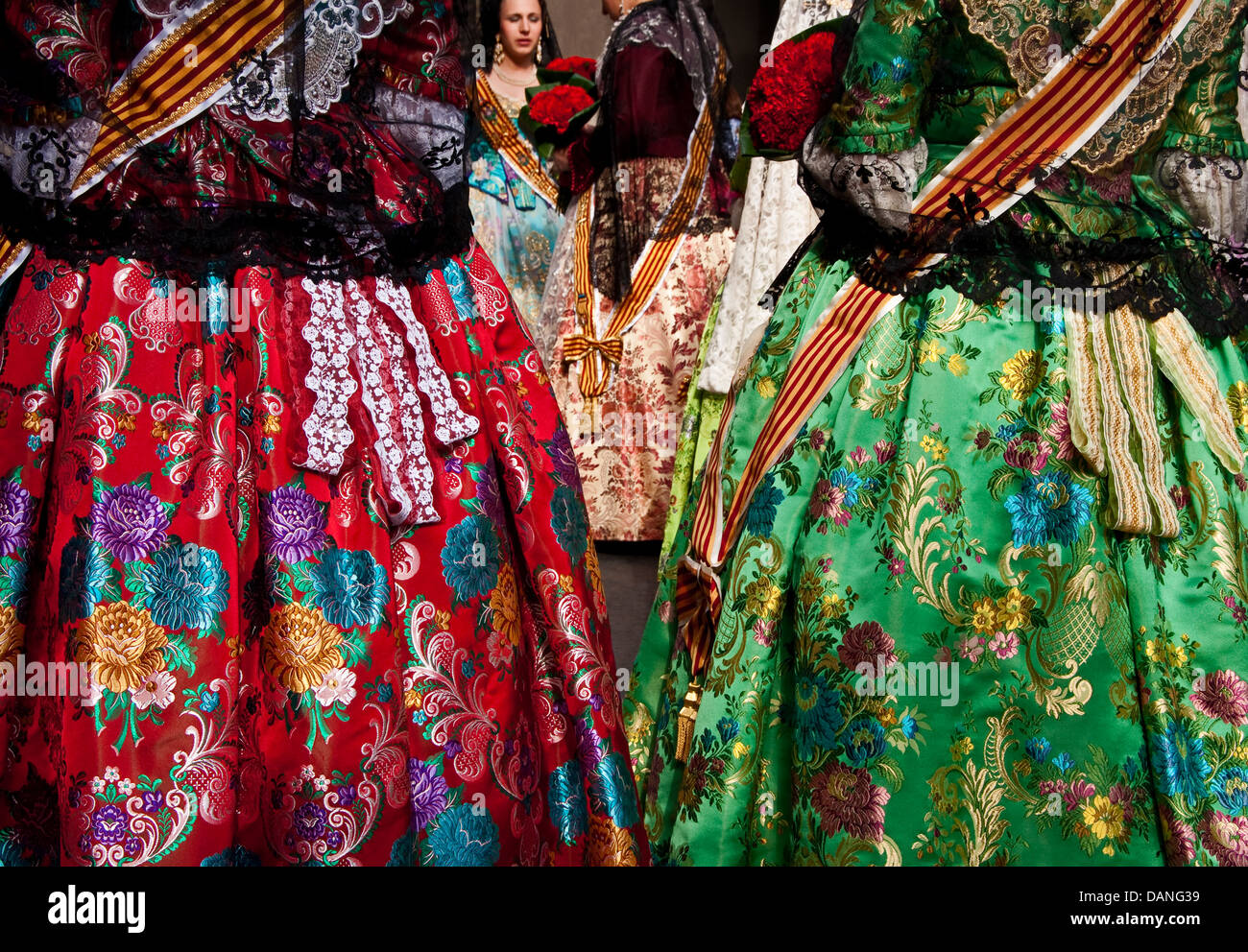 Ornate costumes of falleros during Offering of the Flowers procession ...