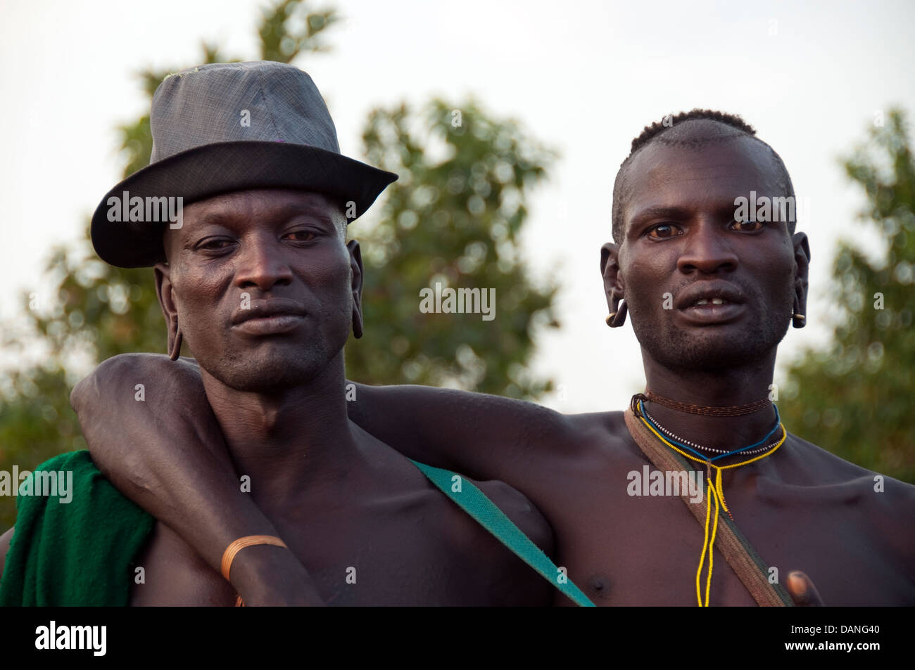 Two Suri (Surma) men embraced, Ethiopia Stock Photo - Alamy