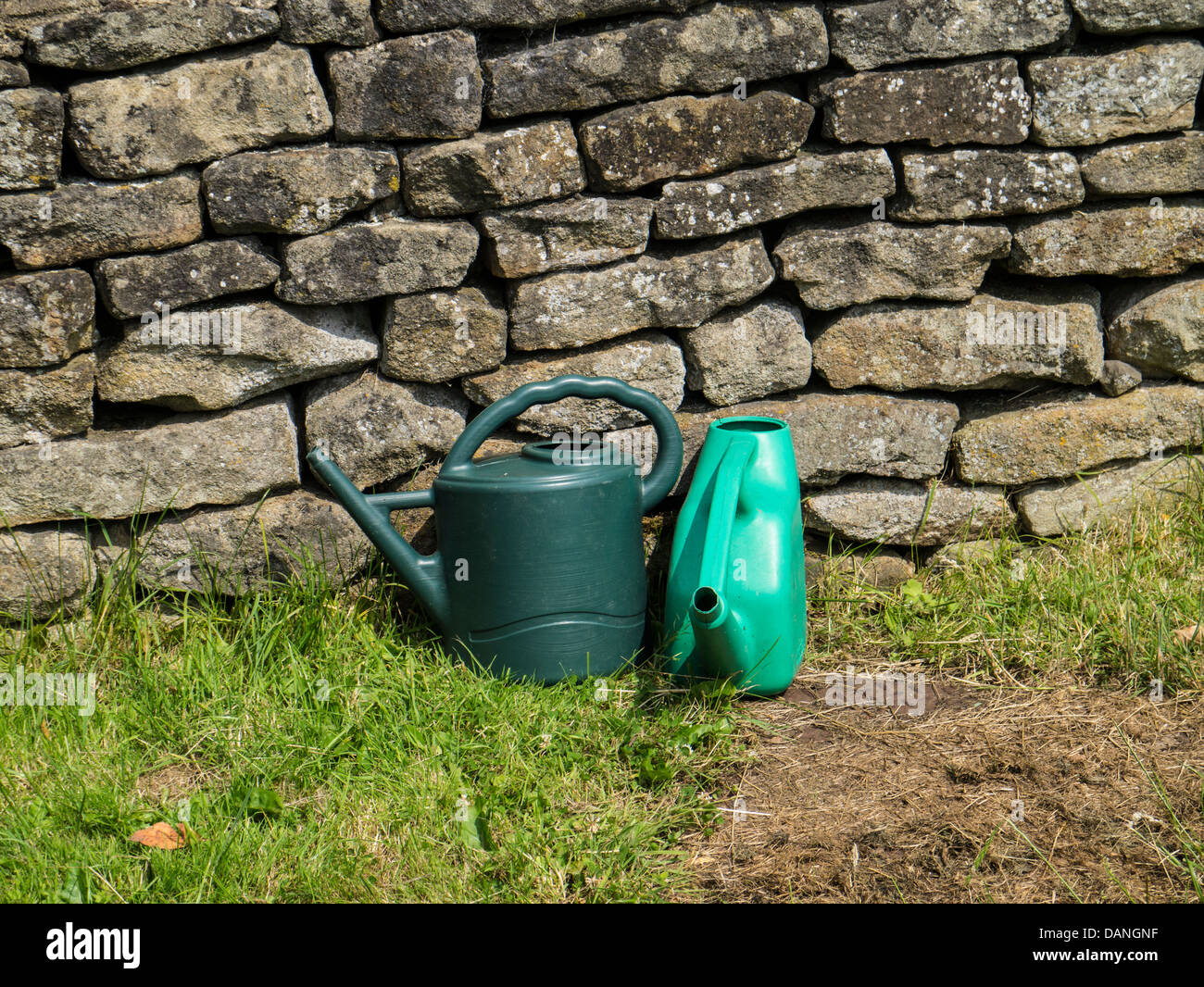 A couple of empty watering cans in the middle of a heatwave waiting for ...