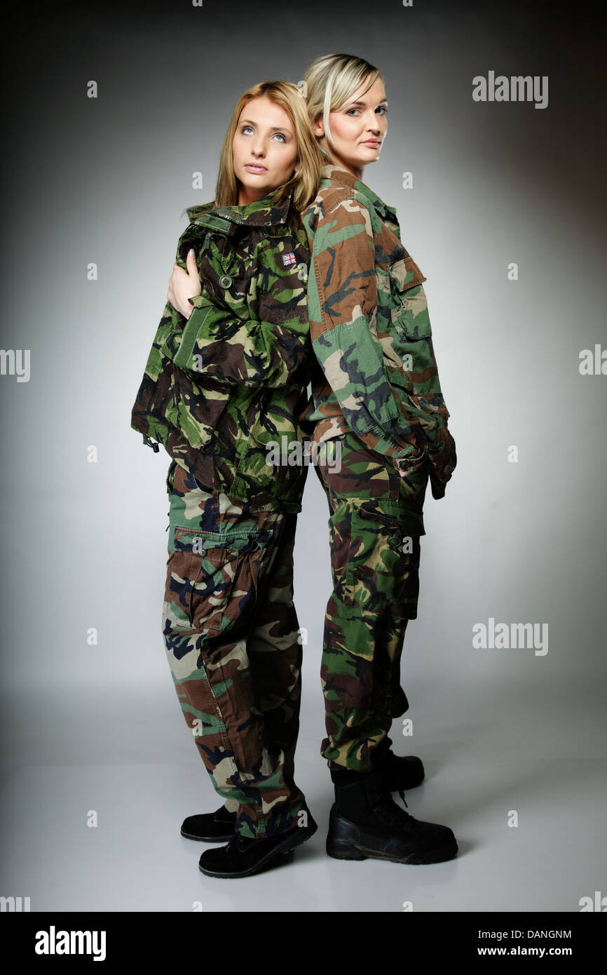 Full length two women in military clothes army girls on gray background ...