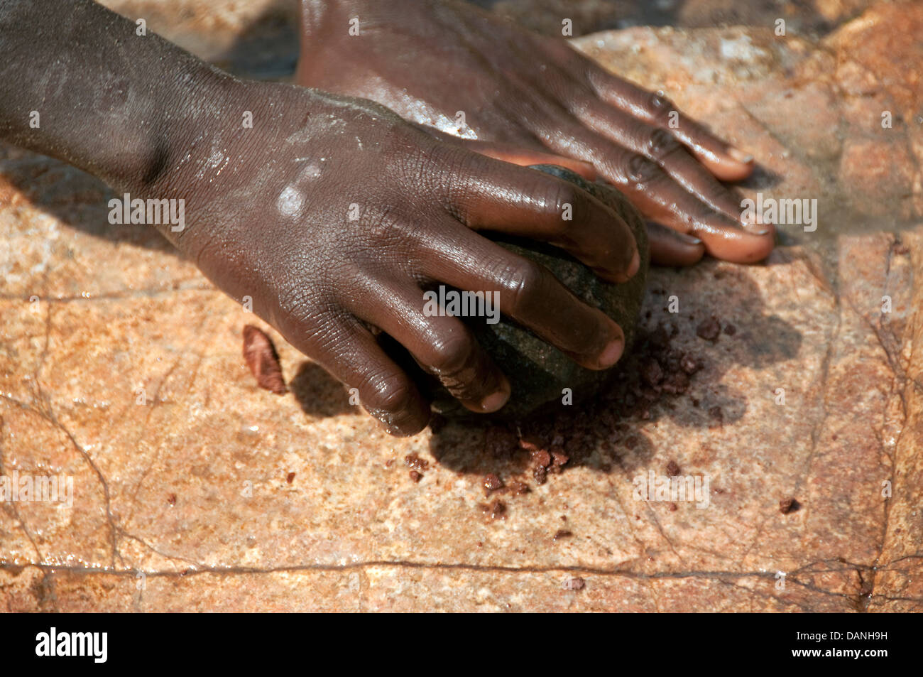 Hands of a Suri (Surma) man preparing color for body painting, Ethiopia ...