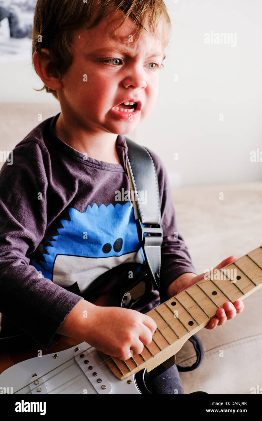 Three year old baby boy playing electric guitar Stock Photo - Alamy
