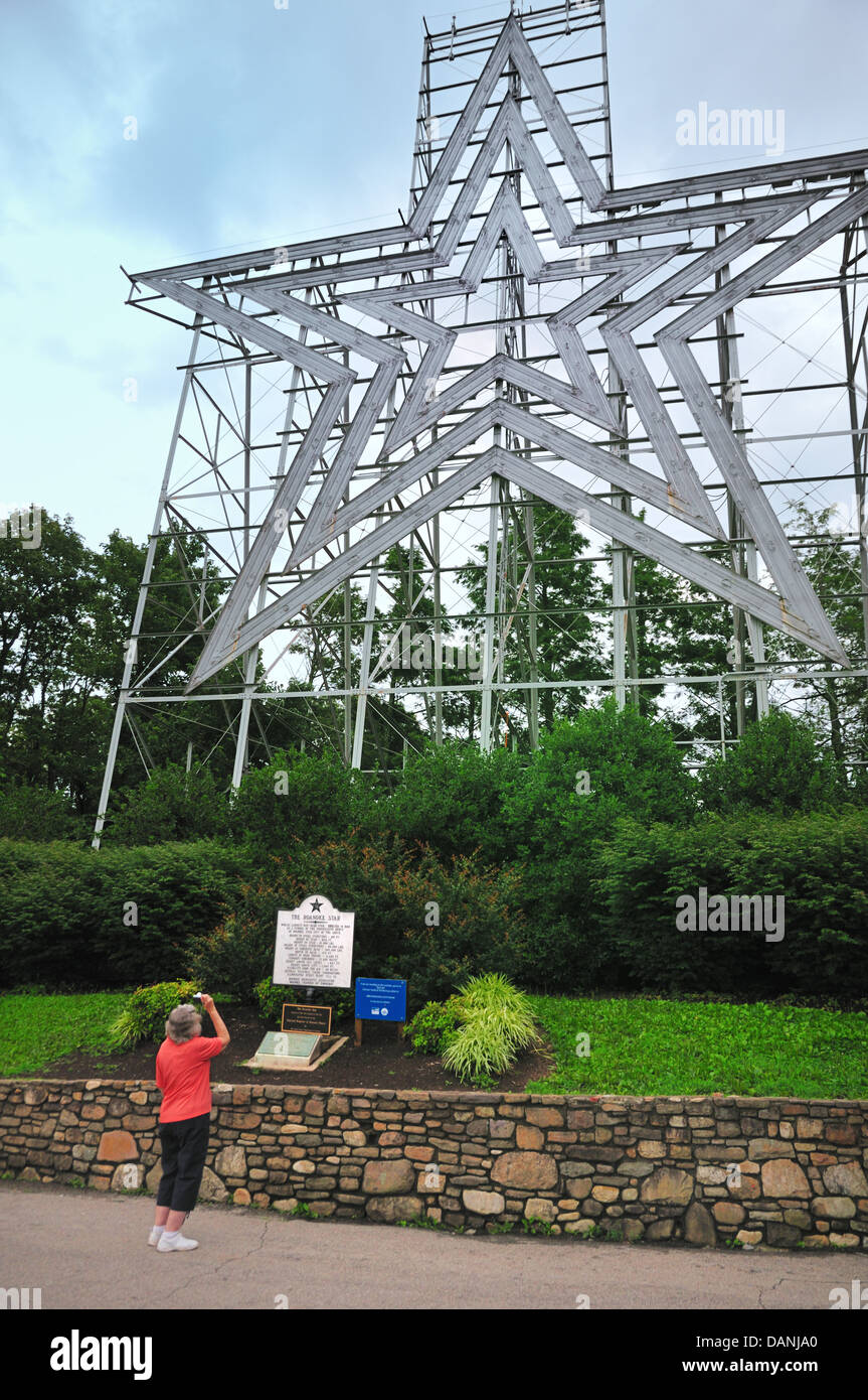 A woman photographs the Roanoke star at the top of Mill Mountain Stock ...
