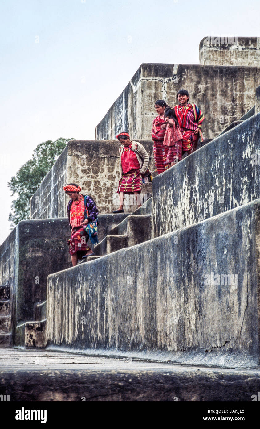 Mayan Mam women in traditional dress climb on the ruins built by their ...