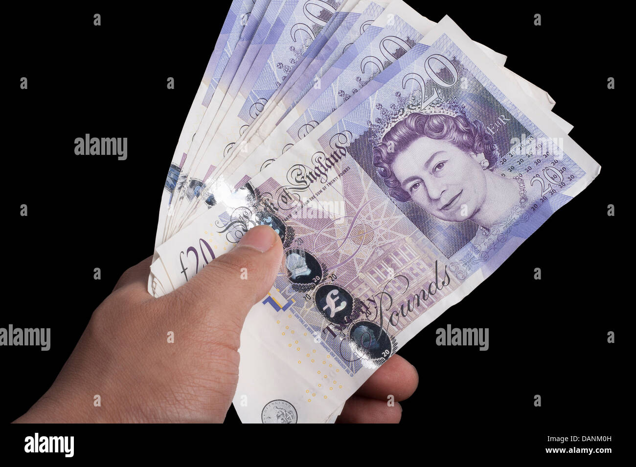 Man holding British notes (twenty pounds), isolated on black Stock ...