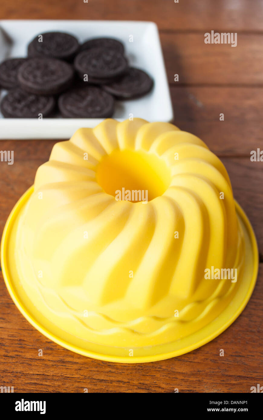 Yellow silicone cake form on wood table, stock photo Stock Photo - Alamy
