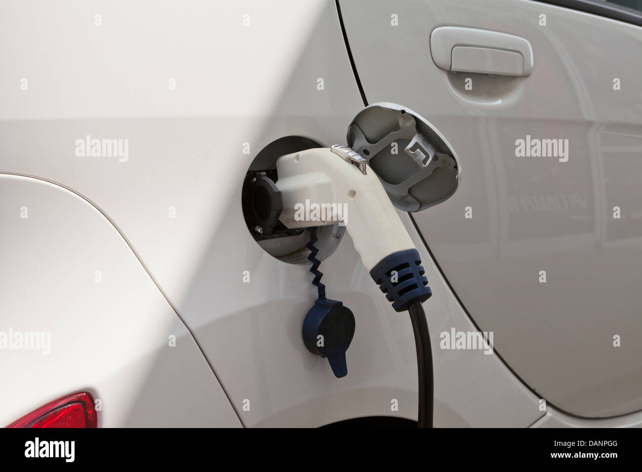 Electric car getting charged Stock Photo - Alamy