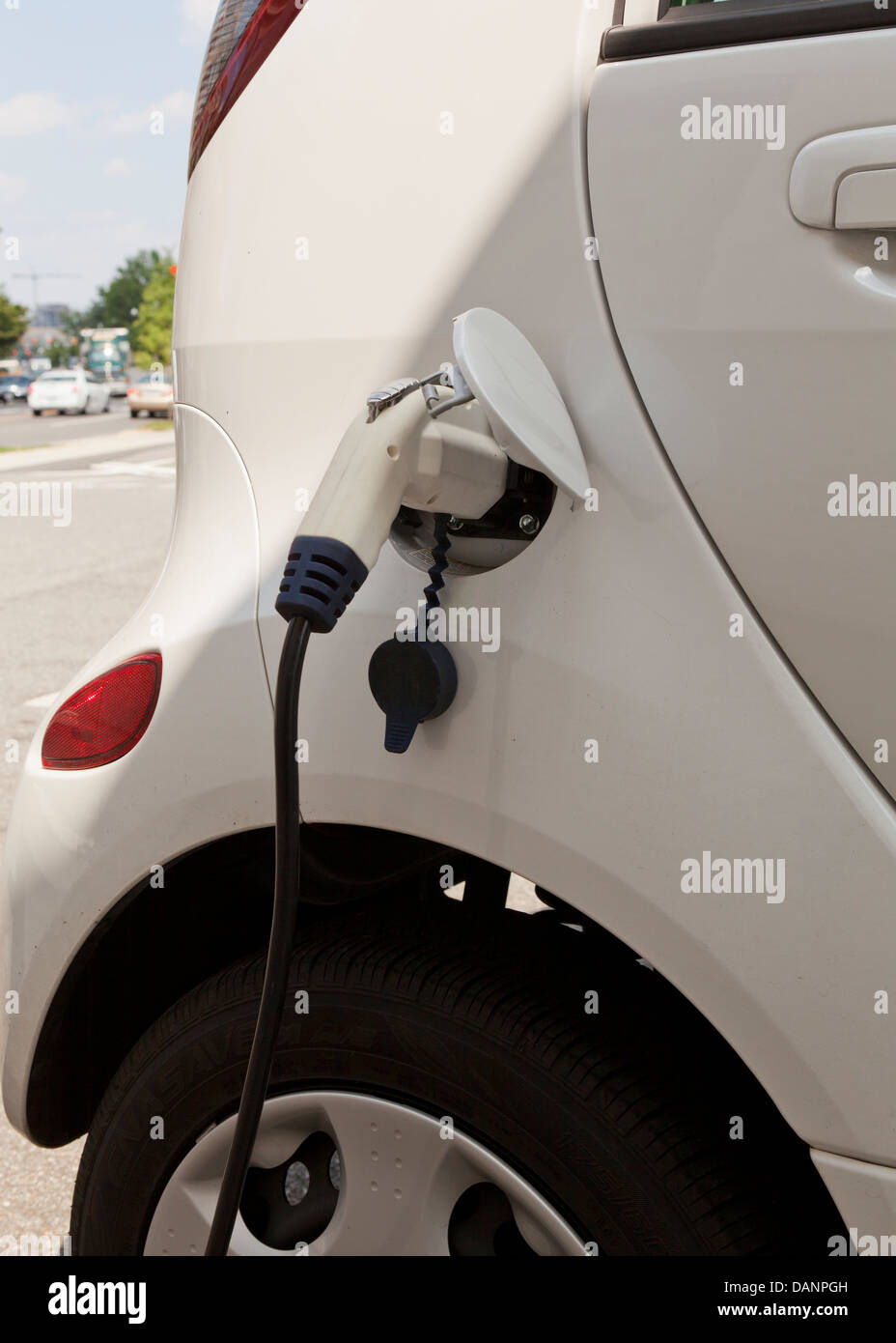 Electric car getting charged Stock Photo - Alamy