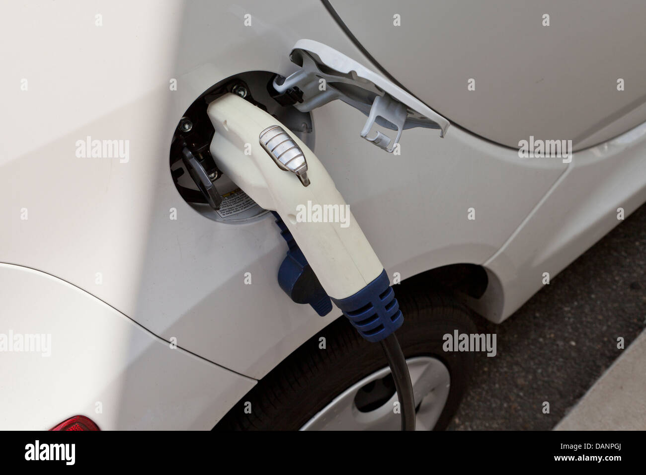 Electric car getting charged Stock Photo - Alamy
