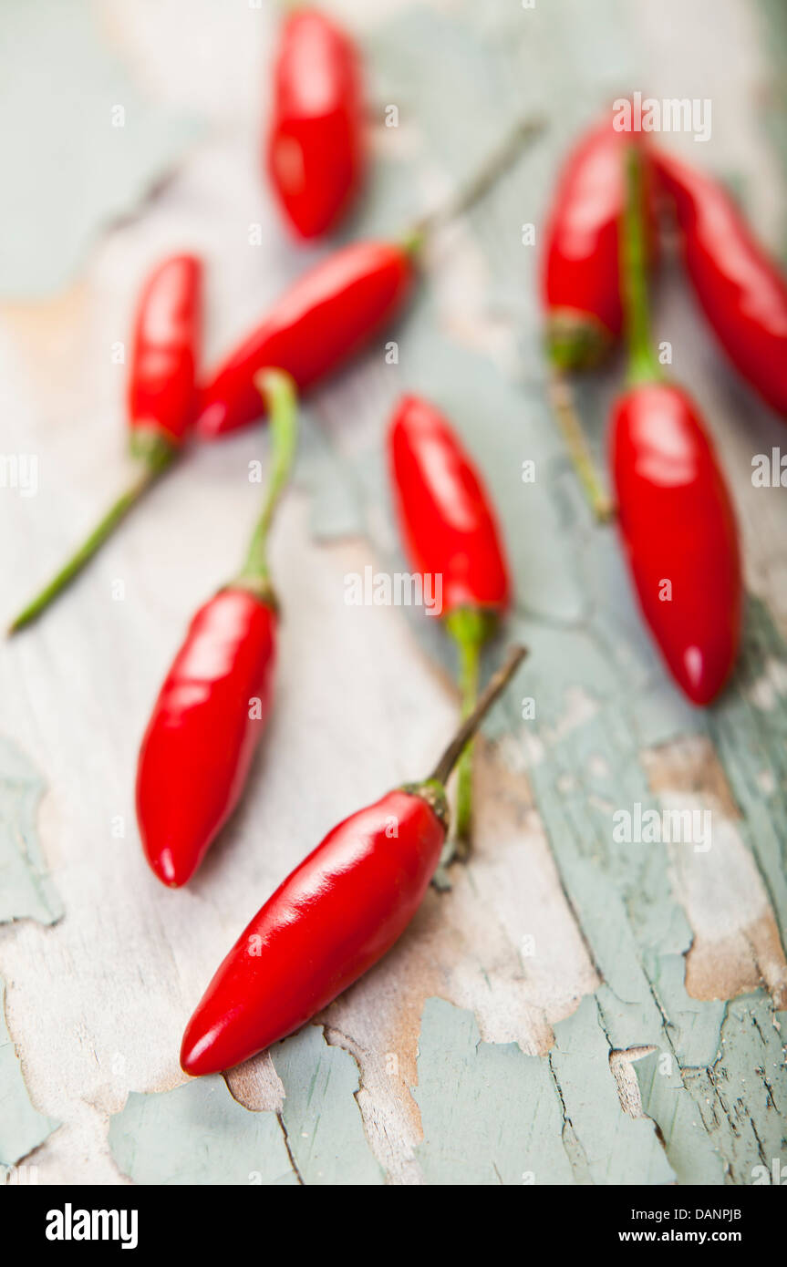 Some red Thai bullet chillies on a cracked painted wood surface Stock ...