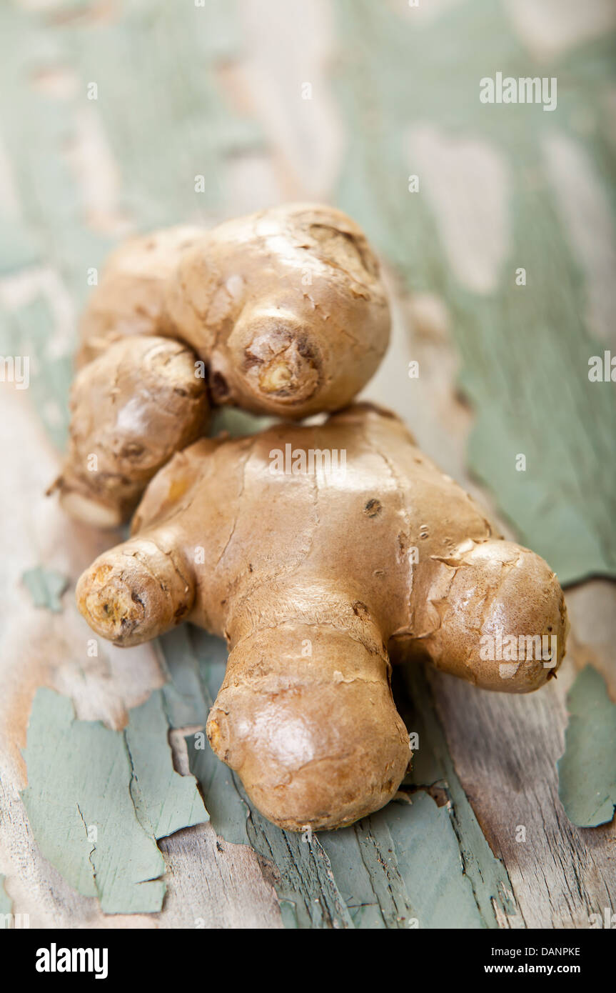 Two fresh whole ginger roots on a cracked painted wood surface Stock ...