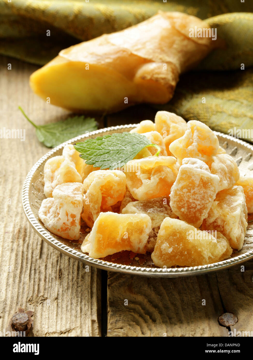 sugared ginger (candied) and fresh root on a wooden table Stock Photo ...