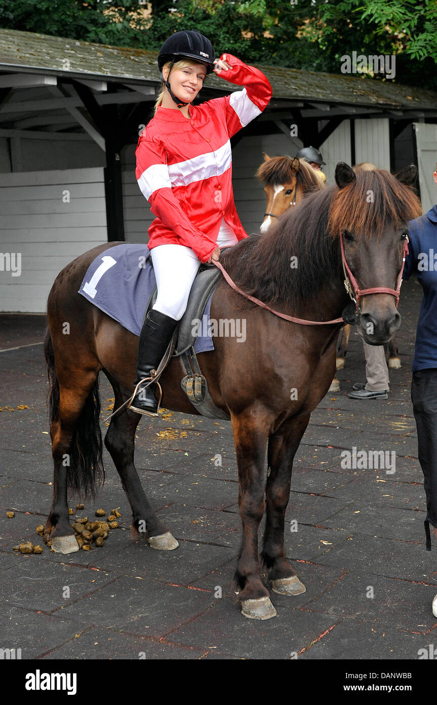 Actress Marylu Poolman sits on a horse at the benefit race day for the ...