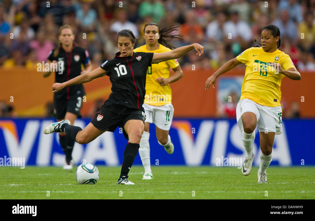 USA s Carli Lloyd (L) against Brazil s Marta and Francielle during the ...