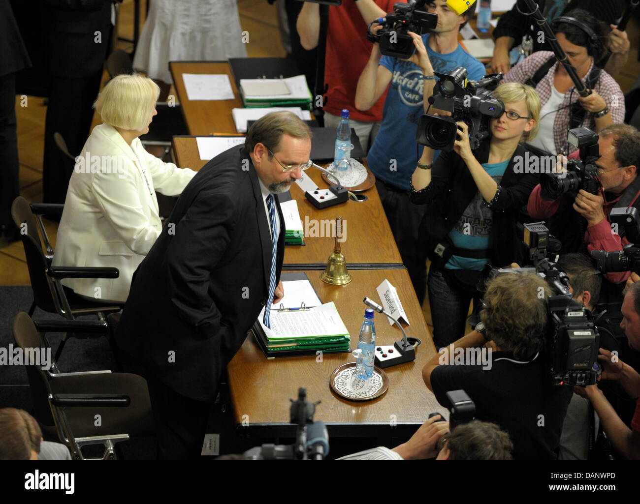 Mayor of Duisburg, Adolf Sauerland (2nd to L), leaves the podium after ...