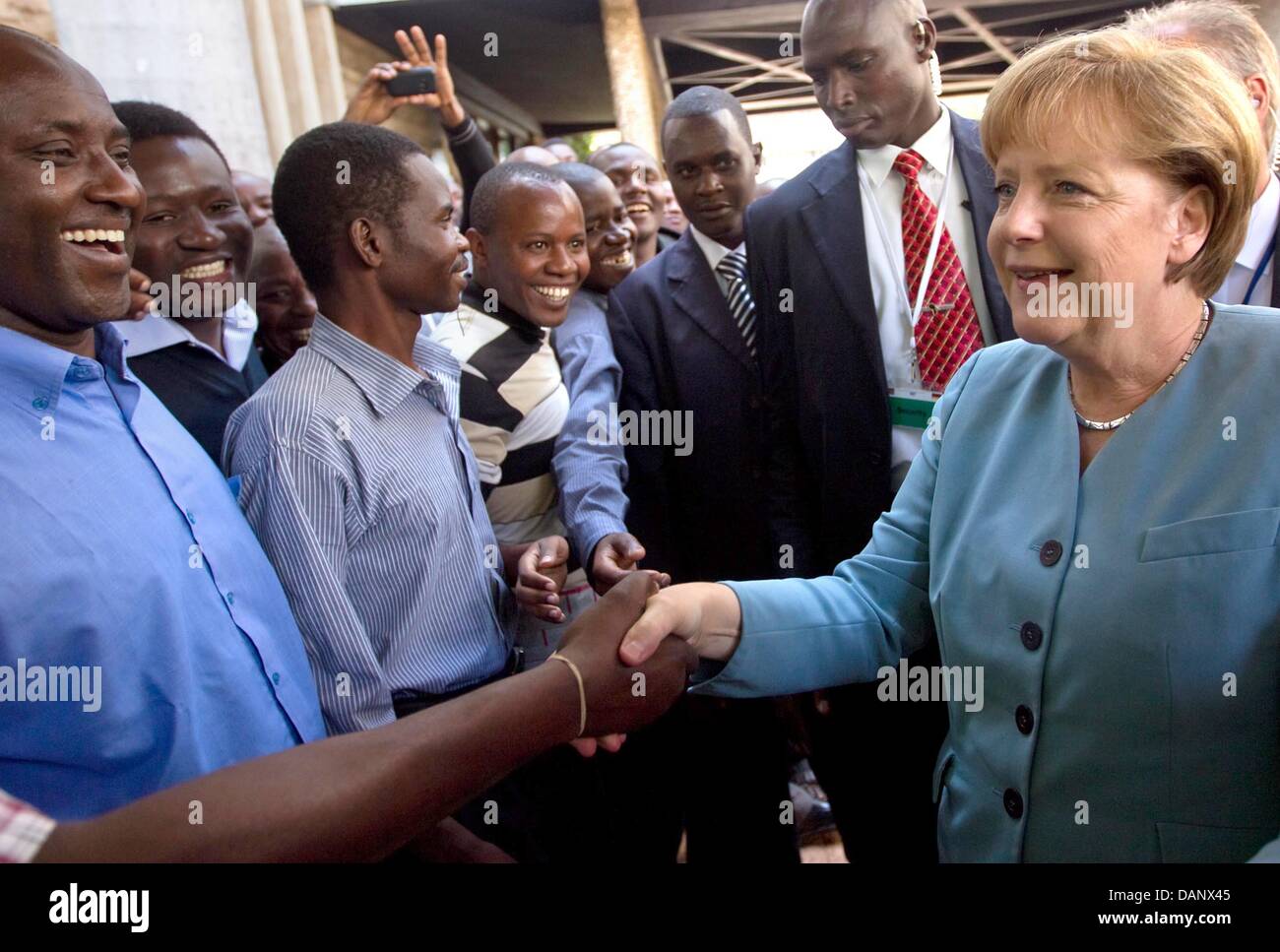 German Chancellor Angela Merkel is welcomed by students of the ...