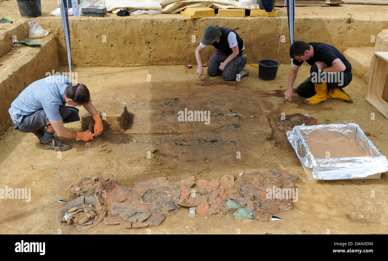 Archaeologist work at a cleared burial site that is around 3000 years ...