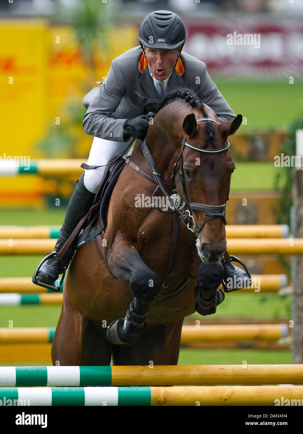 German show jumper Ludger Beerbaum jumps over an obstacle on his horse ...