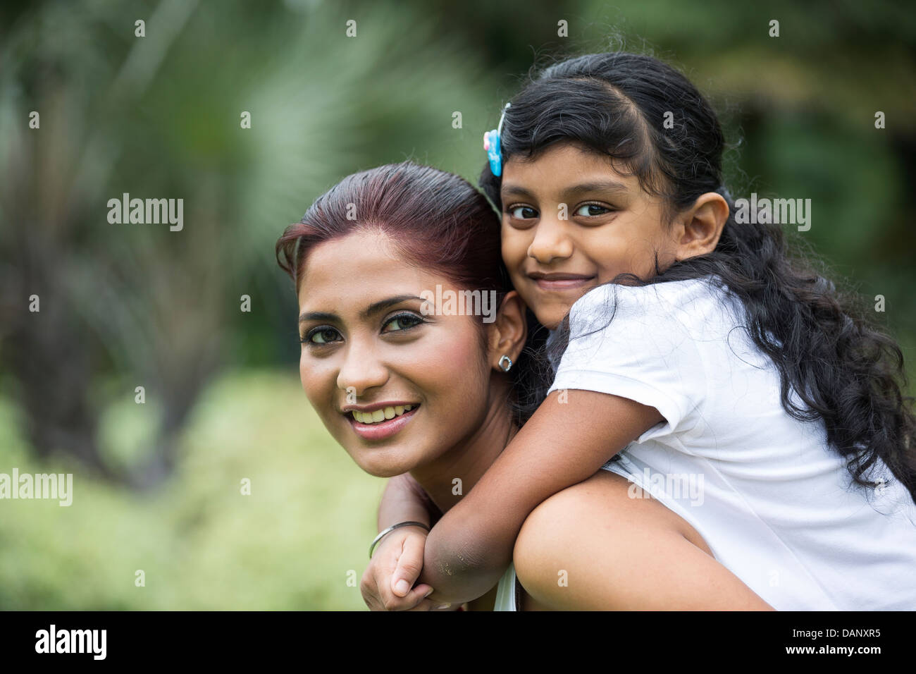 Happy Indian mother and daughter playing in the park. Lifestyle image ...