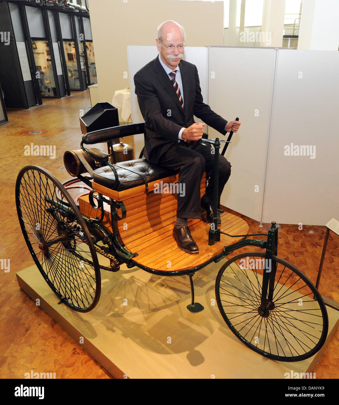Dieter Zetsche, head of the board of Daimler AG, sits on a reproduction ...
