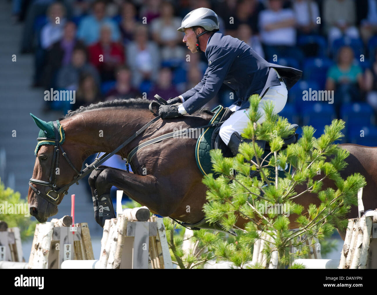German equestrian Hans-Dieter Dreher jumps with his horse Magnus Romeo ...