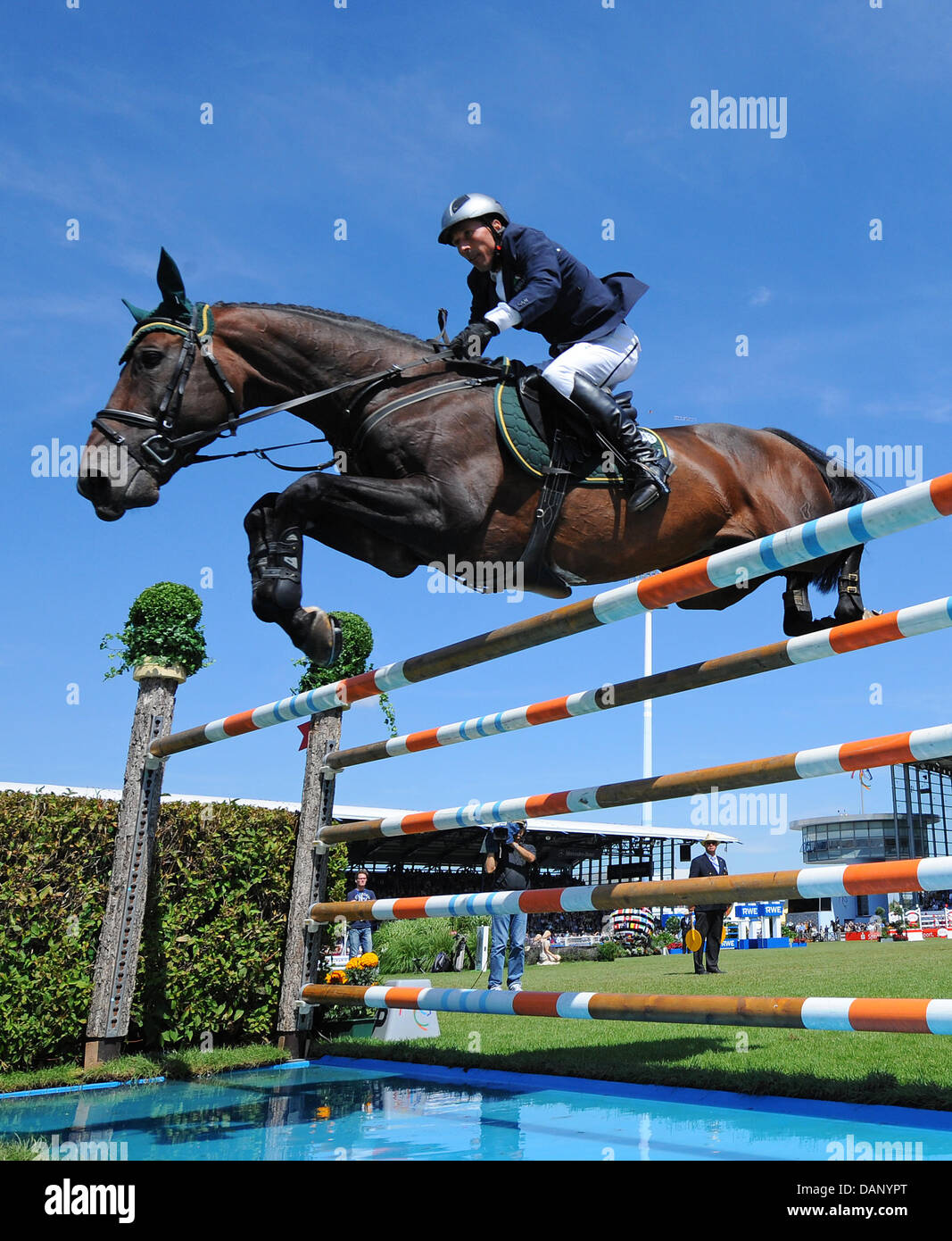 German equestrian Hans-Dieter Dreher jumps with his horse Magnus Romeo ...