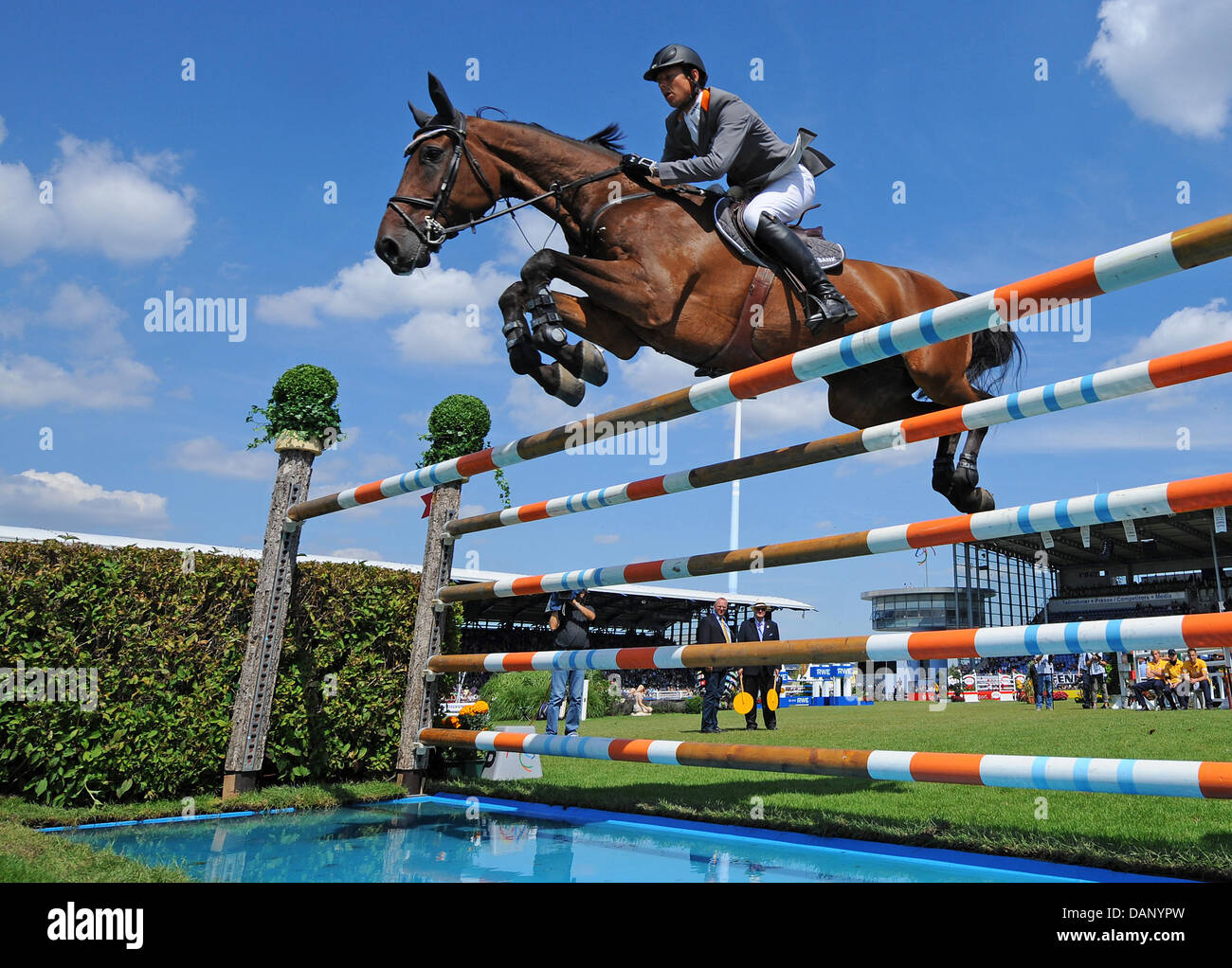 German equestrian Marco Kutscher jumps with his horse Cash during the ...