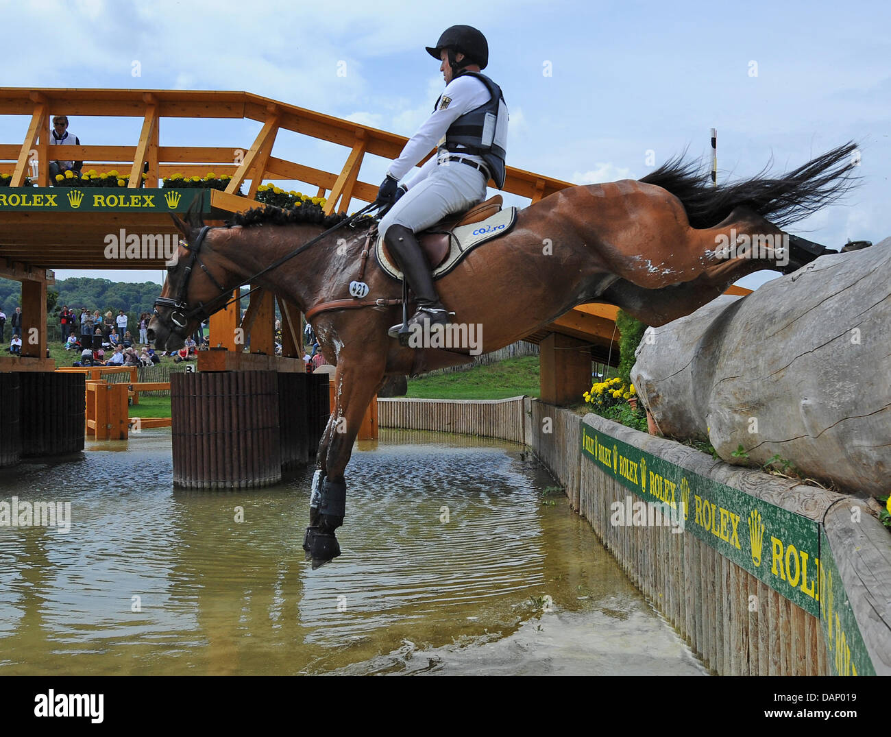 German eventing equestrian Michael Jung jumps over a natural obstacle ...
