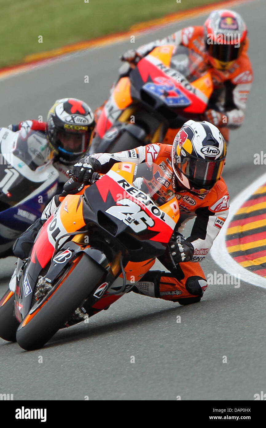 Spanish Honda pilot Daniel Pedrosa (FRONT) is followed by Spanish ...