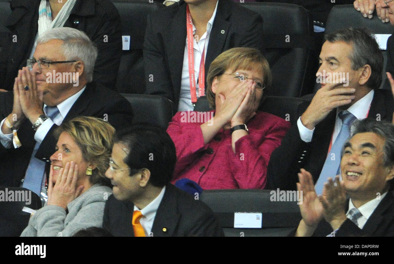 German Chancellor Angela Merkel (C, CDU) sits between DFB-President ...
