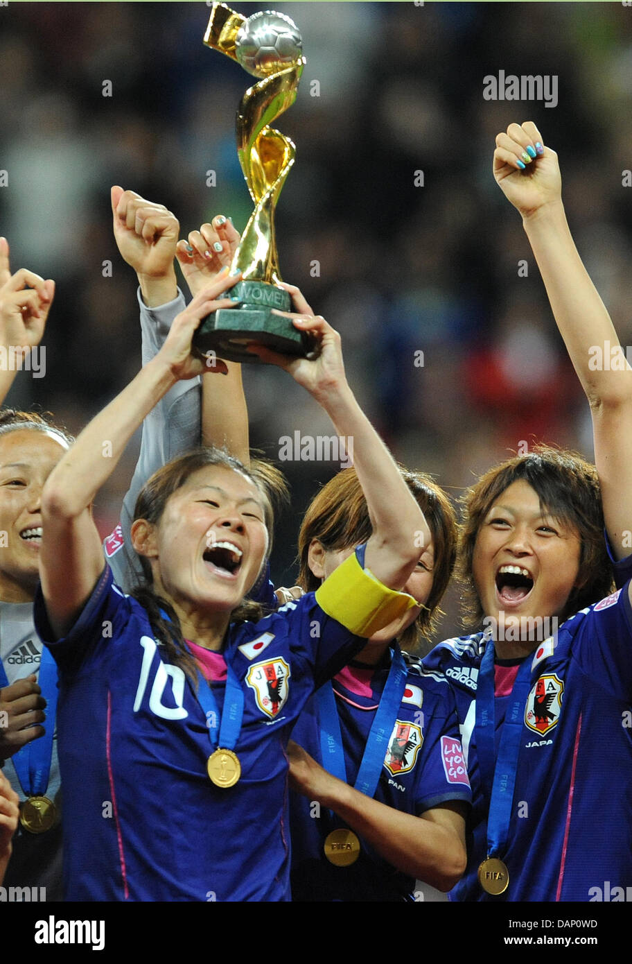 Japan's team around Homare Sawa celebrate with the trophy after the ...