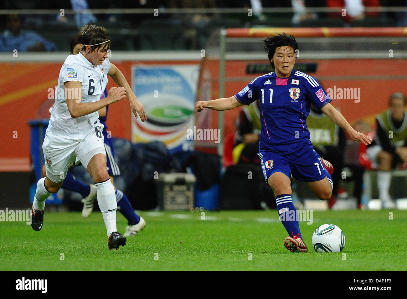 Japanese national soccer player Shinobu Ohno (R) runs ahead of Amy le ...