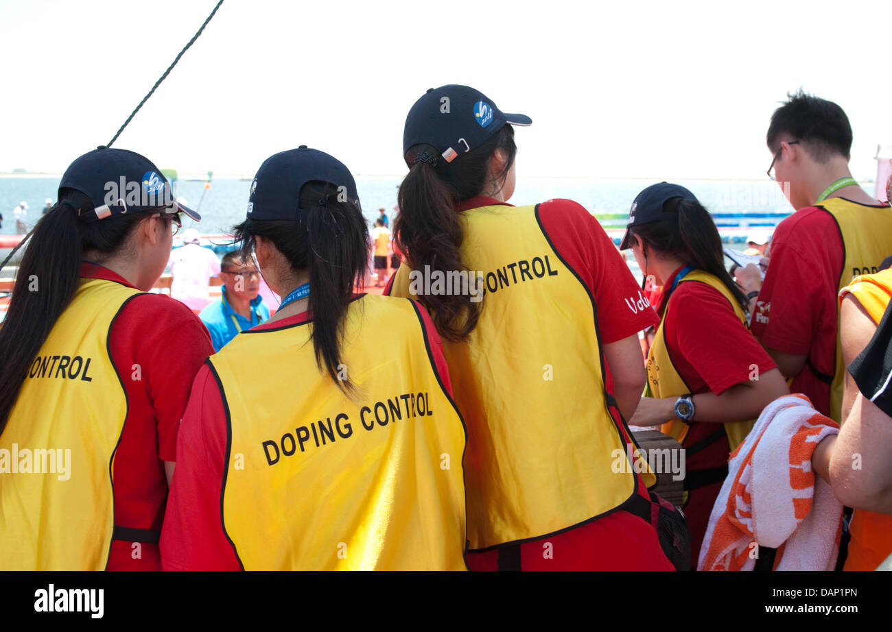Volunteers wearing vest with labels reading label "doping control" at ...