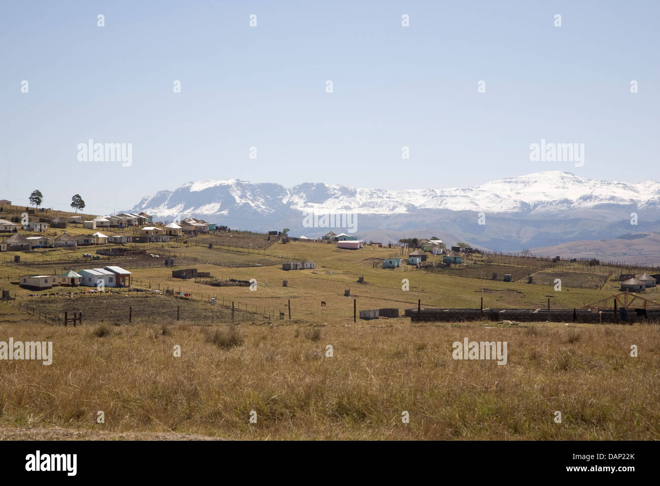 Xhosa homesteads seen against backdrop Ingeli Mountain covered in snow ...
