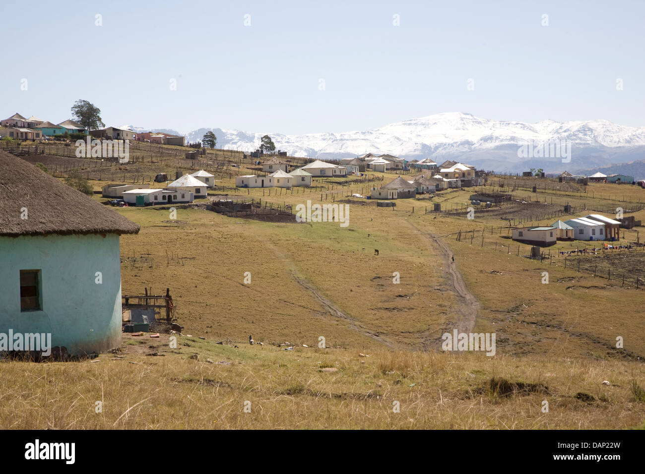 Xhosa homesteads seen against backdrop Ingeli Mountain covered in snow ...
